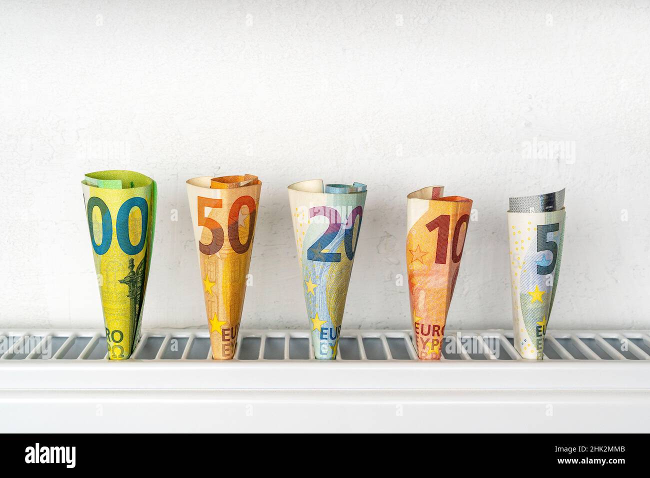 Money on heating battery. Euro banknotes in a central heating radiator ...