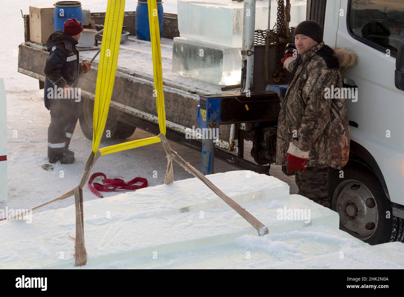 Two assembler workers store ice slabs at the construction site of the ...