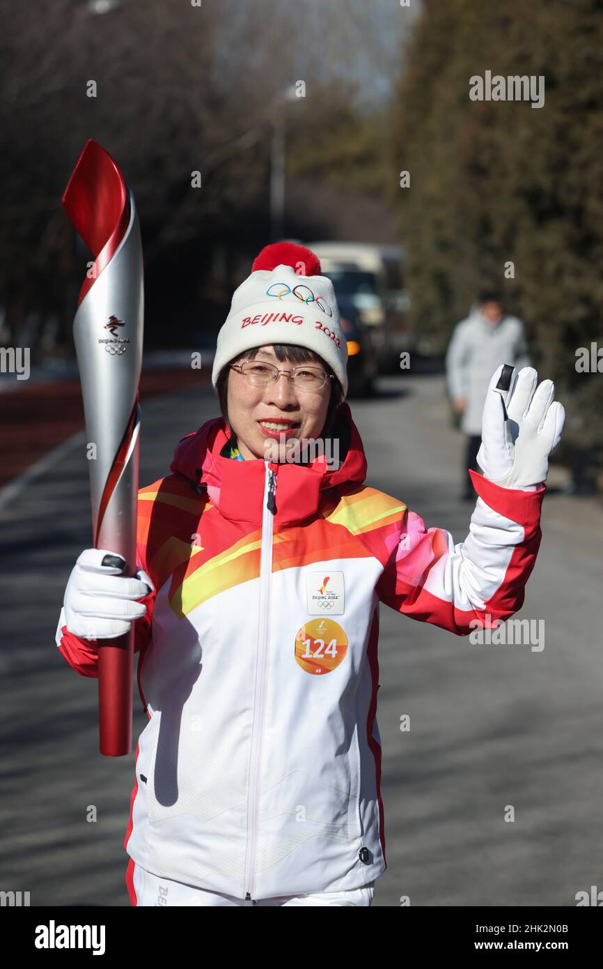 Beijing, China. 2nd Feb, 2022. Torch bearer Yang Ping runs with the torch during the Beijing ...