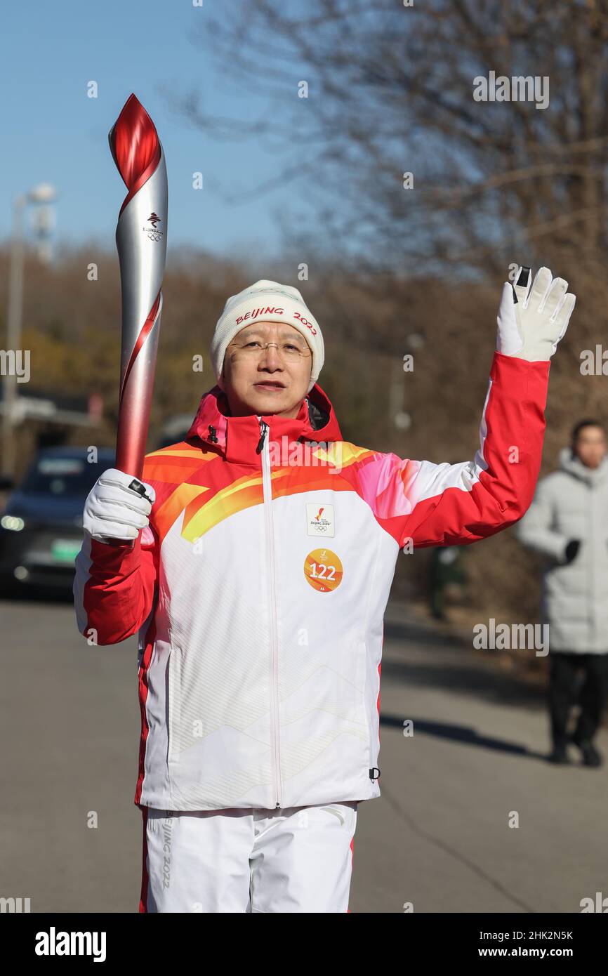 Beijing, China. 2nd Feb, 2022. Torch bearer Wang Haifeng runs with the ...