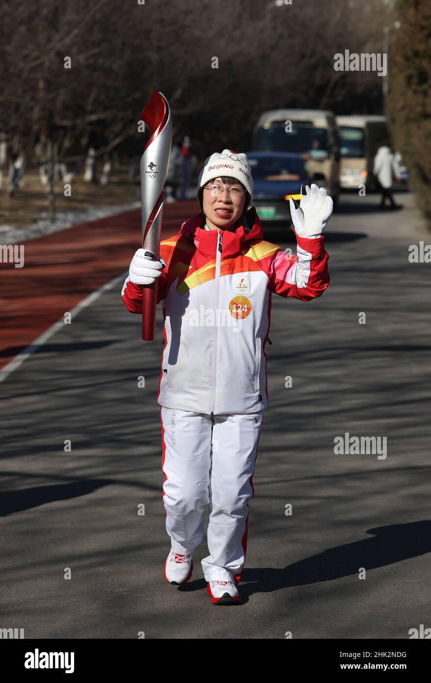 Beijing, China. 2nd Feb, 2022. Torch bearer Yang Ping runs with the torch during the Beijing ...