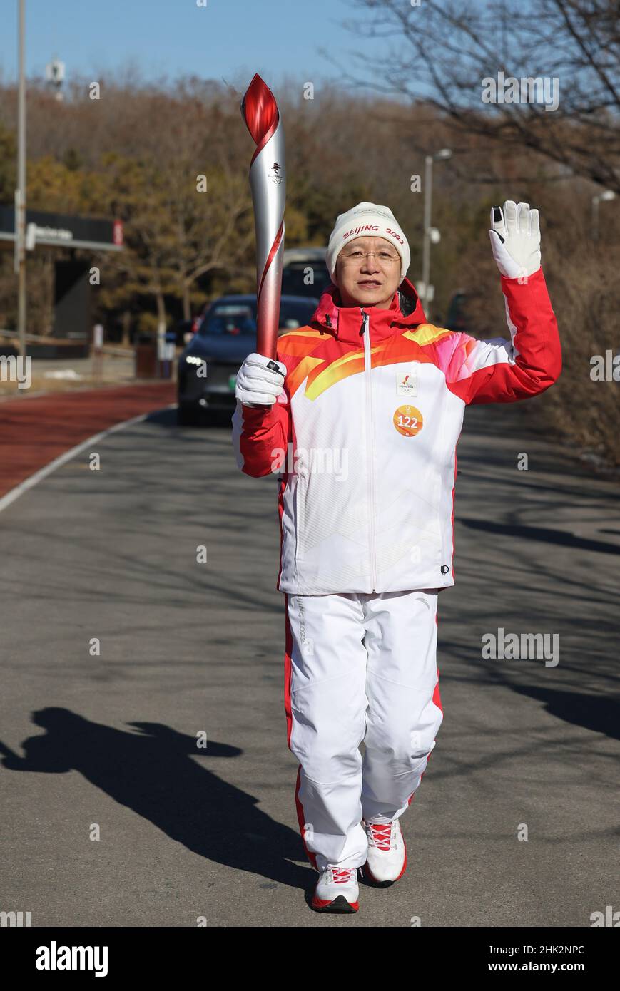Beijing, China. 2nd Feb, 2022. Torch bearer Wang Haifeng runs with the ...