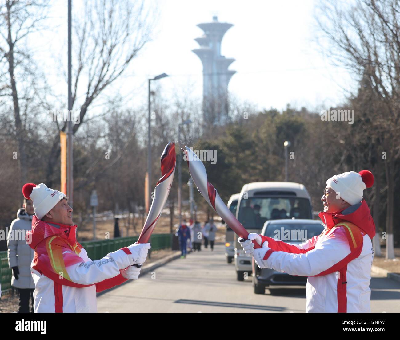 Beijing, China. 2nd Feb, 2022. Torch bearer Song Luzeng (R) hands over ...