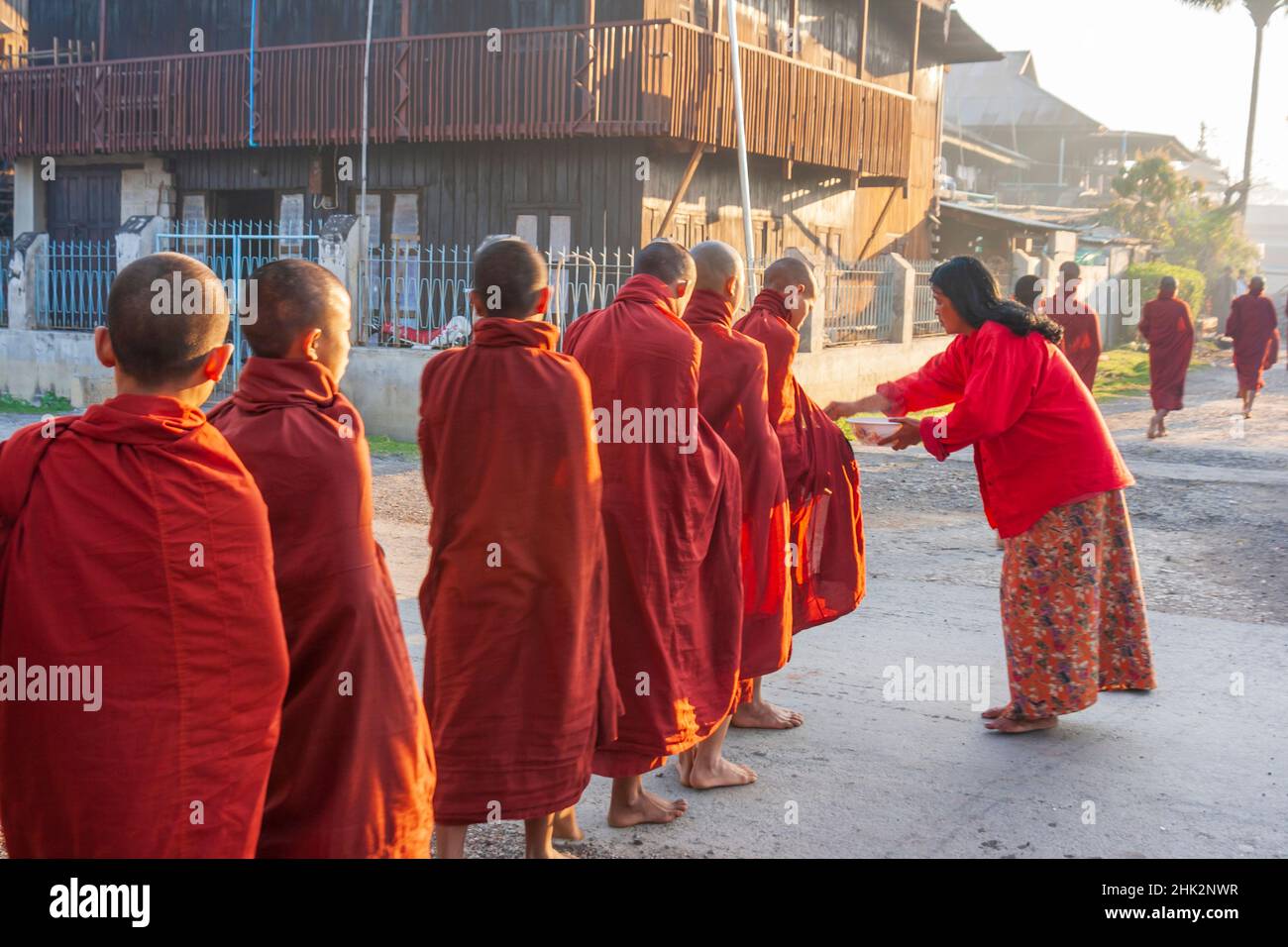 Inlay Lake, Shan State, Myanmar. Buddhist monks being given offerings ...