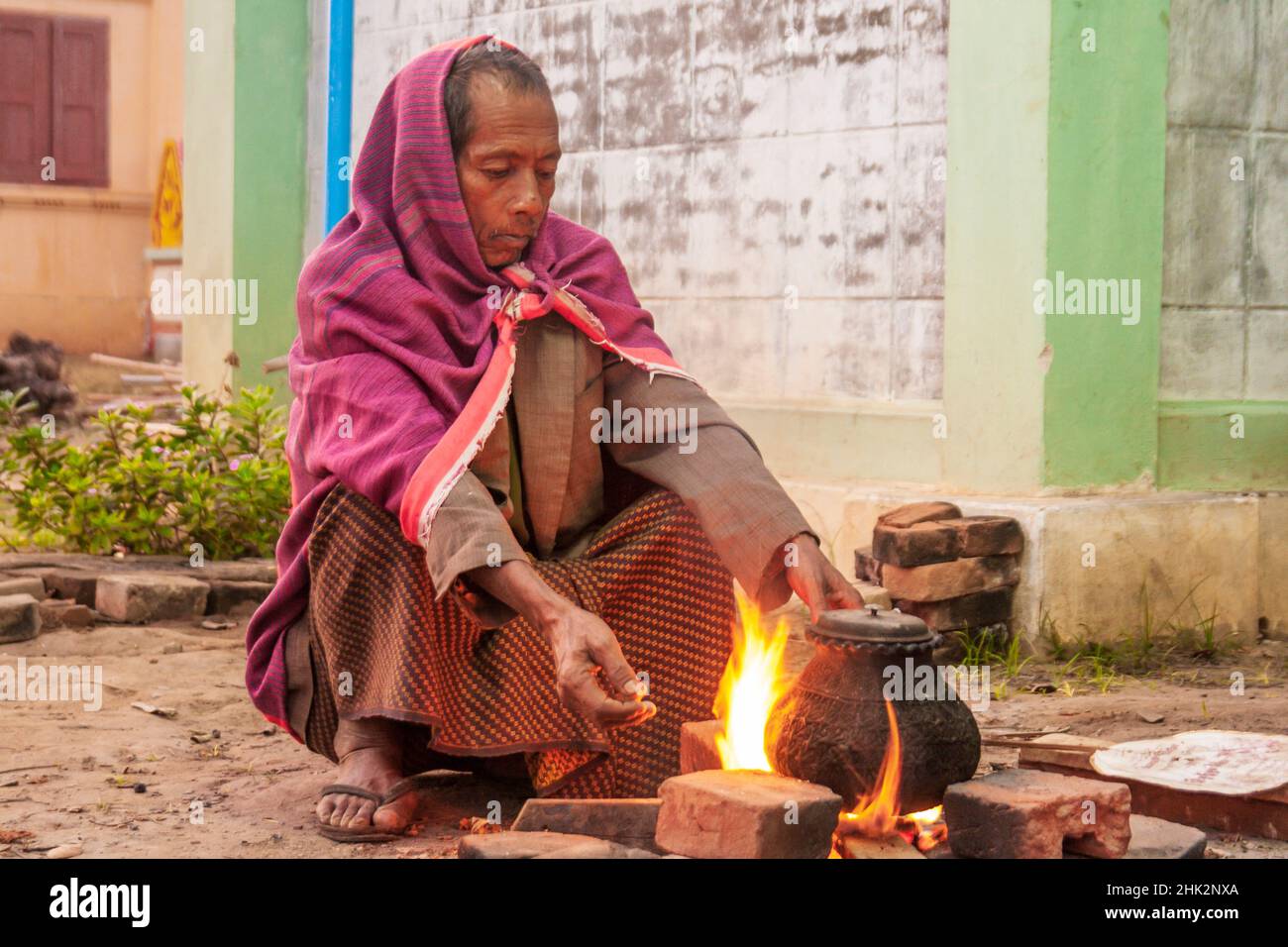 Make Tehi Lar, Myanmar. Man heating a pot over an open fire. (Editorial ...