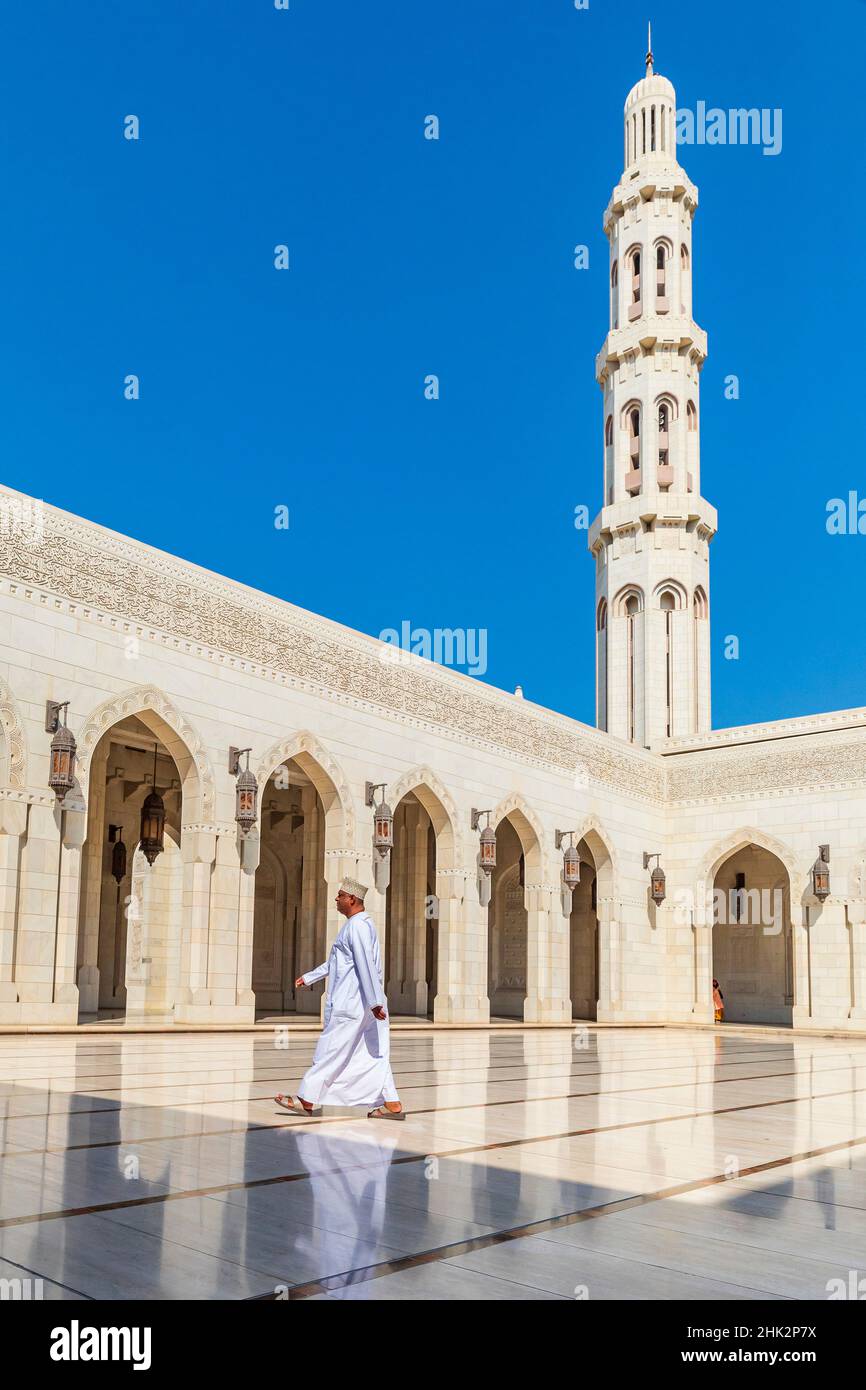 Middle East, Arabian Peninsula, Oman, Muscat. Man walking through the ...