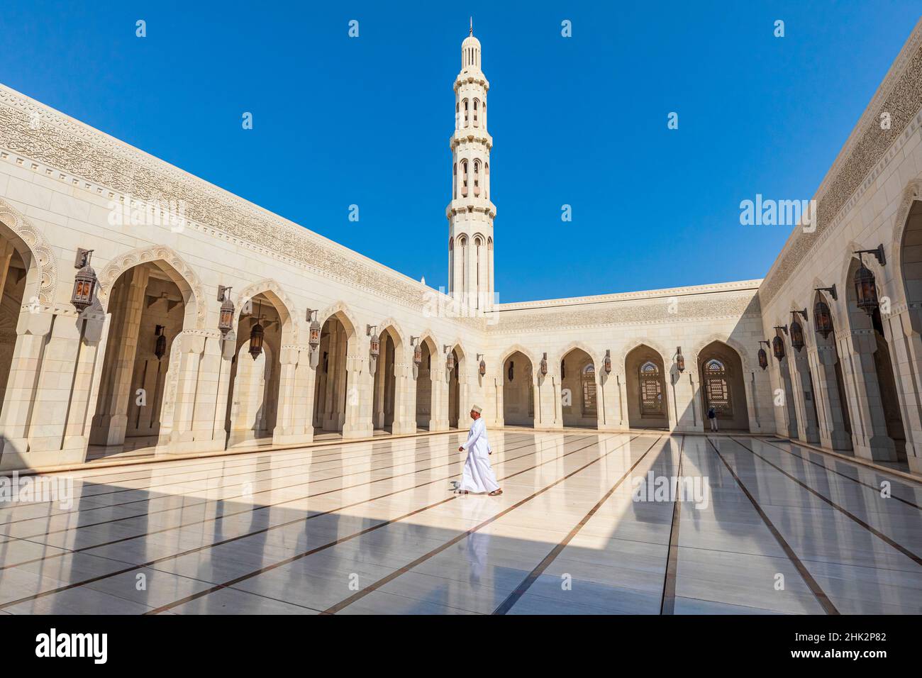 Middle East, Arabian Peninsula, Oman, Muscat. Man walking through the ...