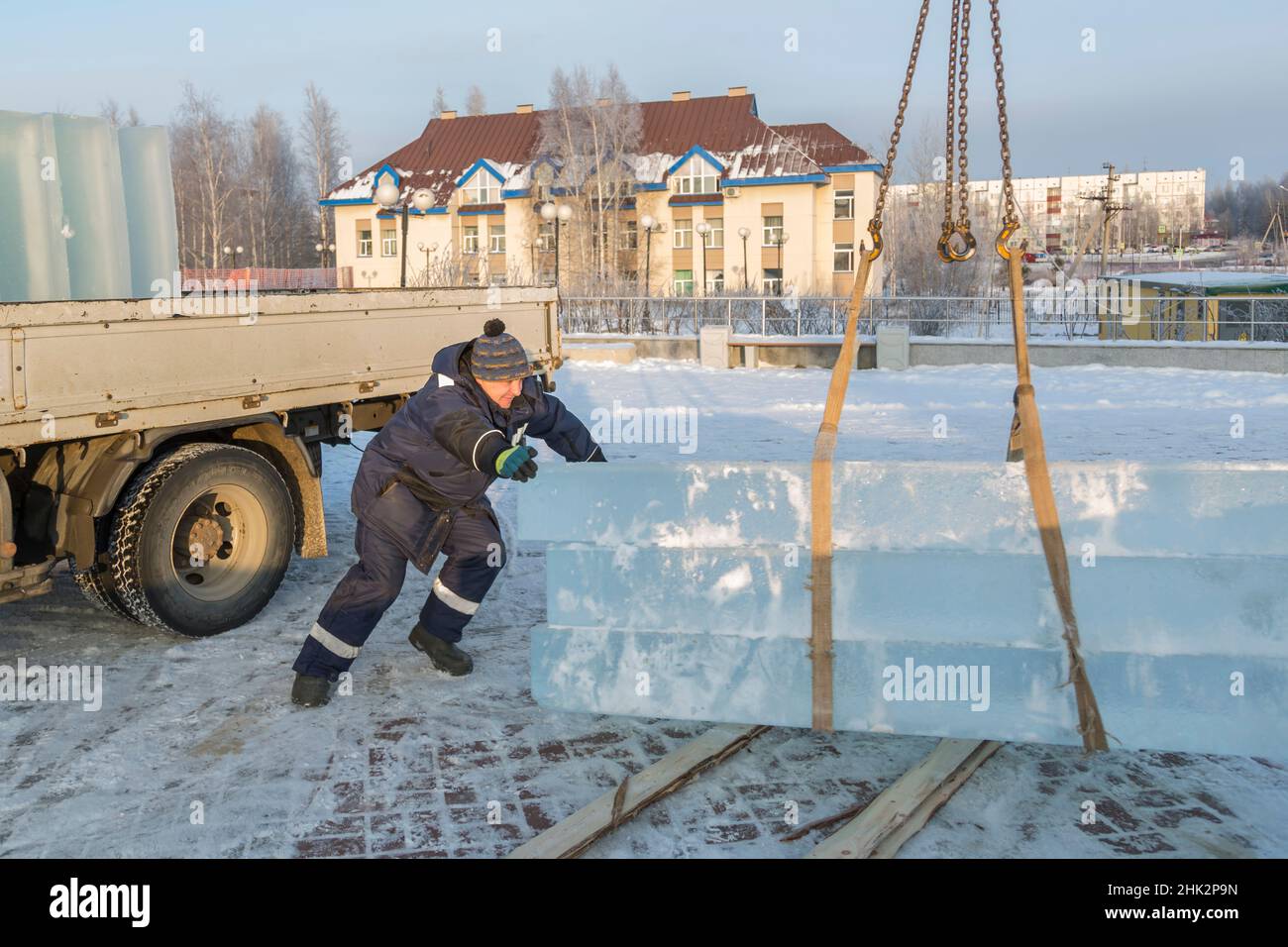 Two assembly workers unload ice plates from the body of a car Stock ...