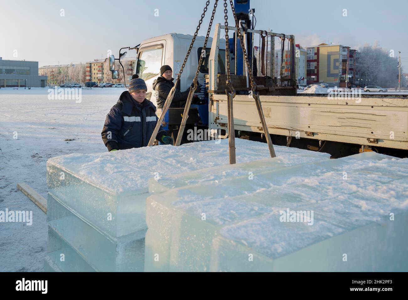 Two assembler workers store ice slabs at the construction site of the ...