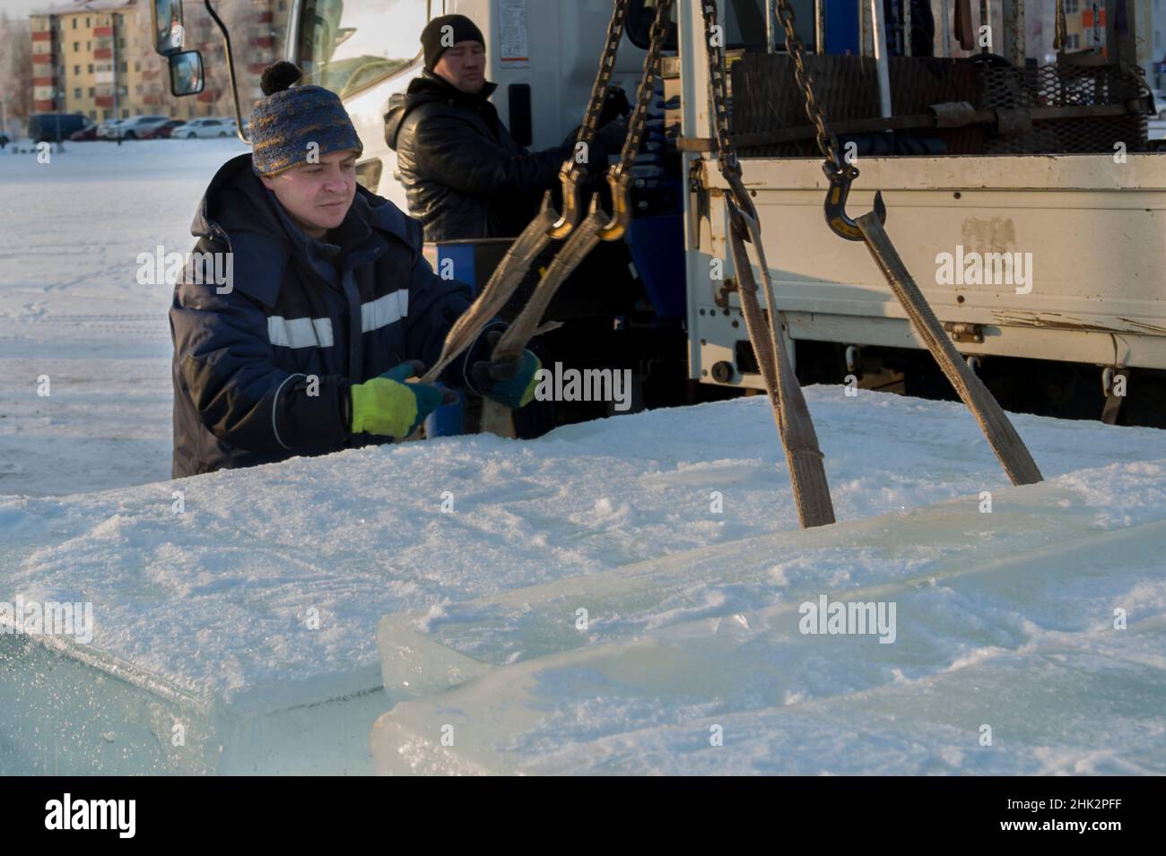 Two assembler workers store ice slabs at the construction site of the ...