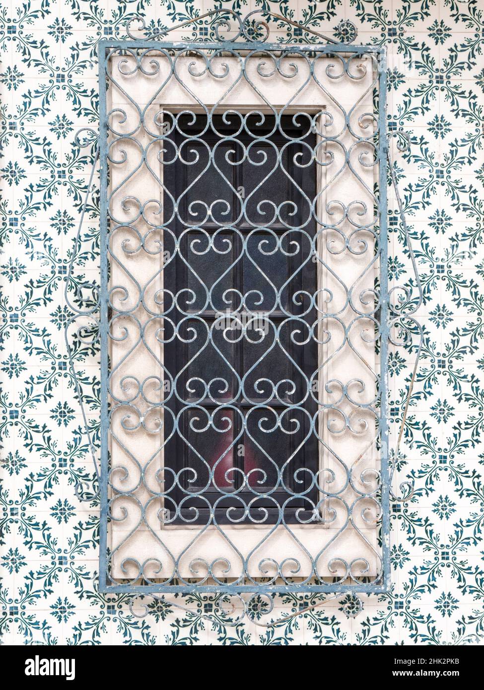 Portugal, Aveiro. Shuttered window on tiled wall with wrought iron ...