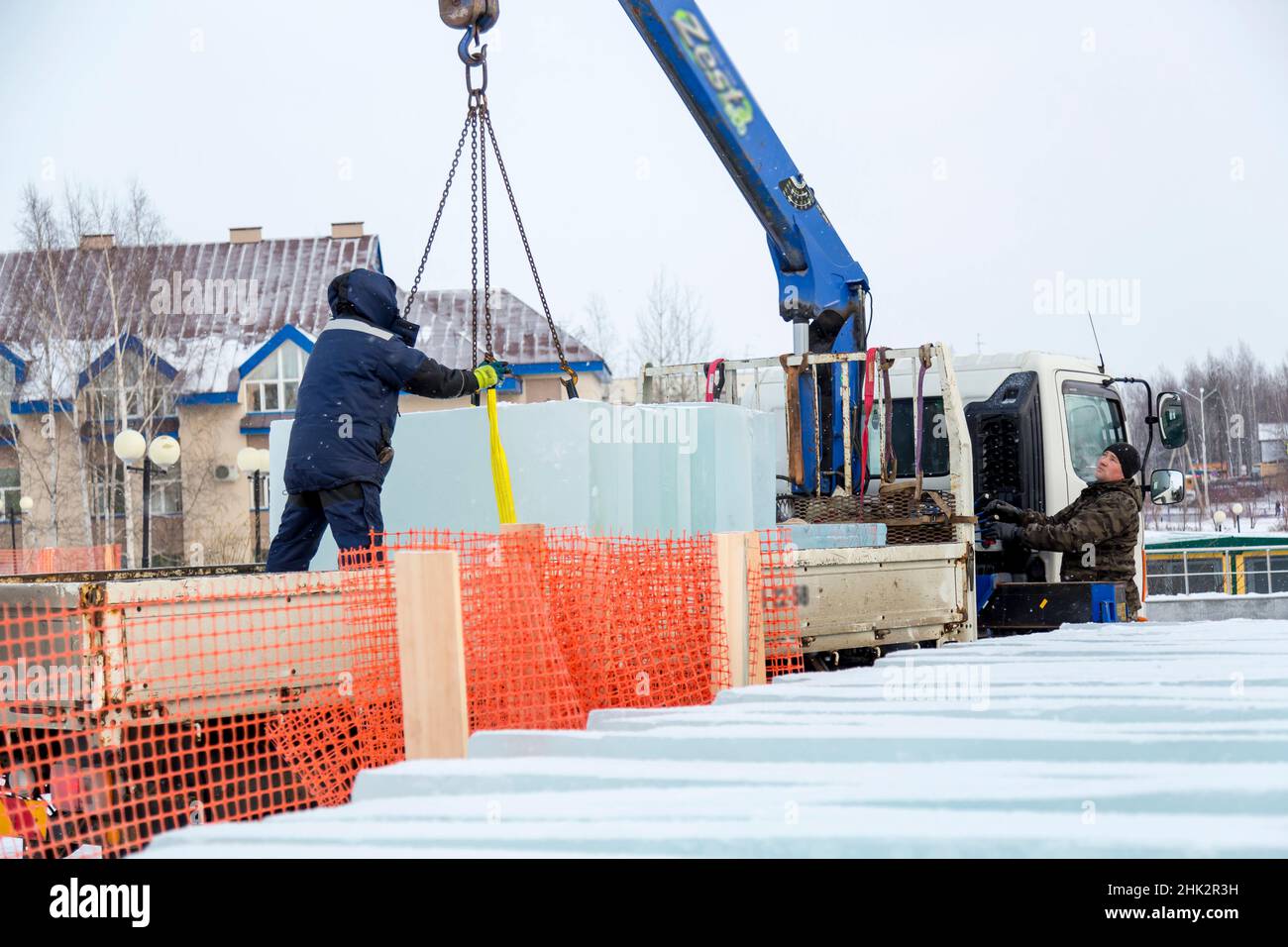 Two assembly workers unload ice plates from the body of a car Stock ...