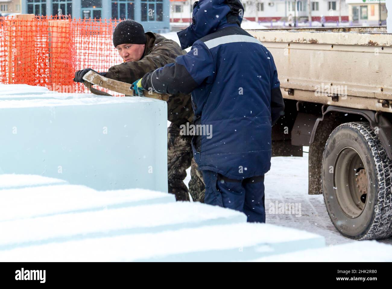 Two assembler workers store ice slabs at the construction site of the ...