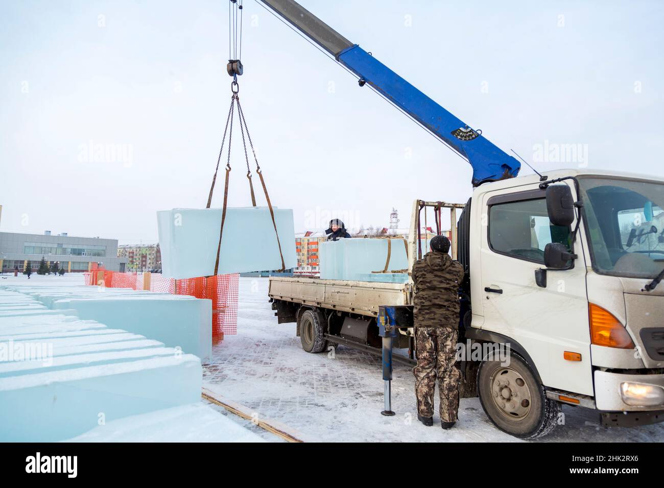 Two assembly workers unload ice plates from the body of a car Stock ...