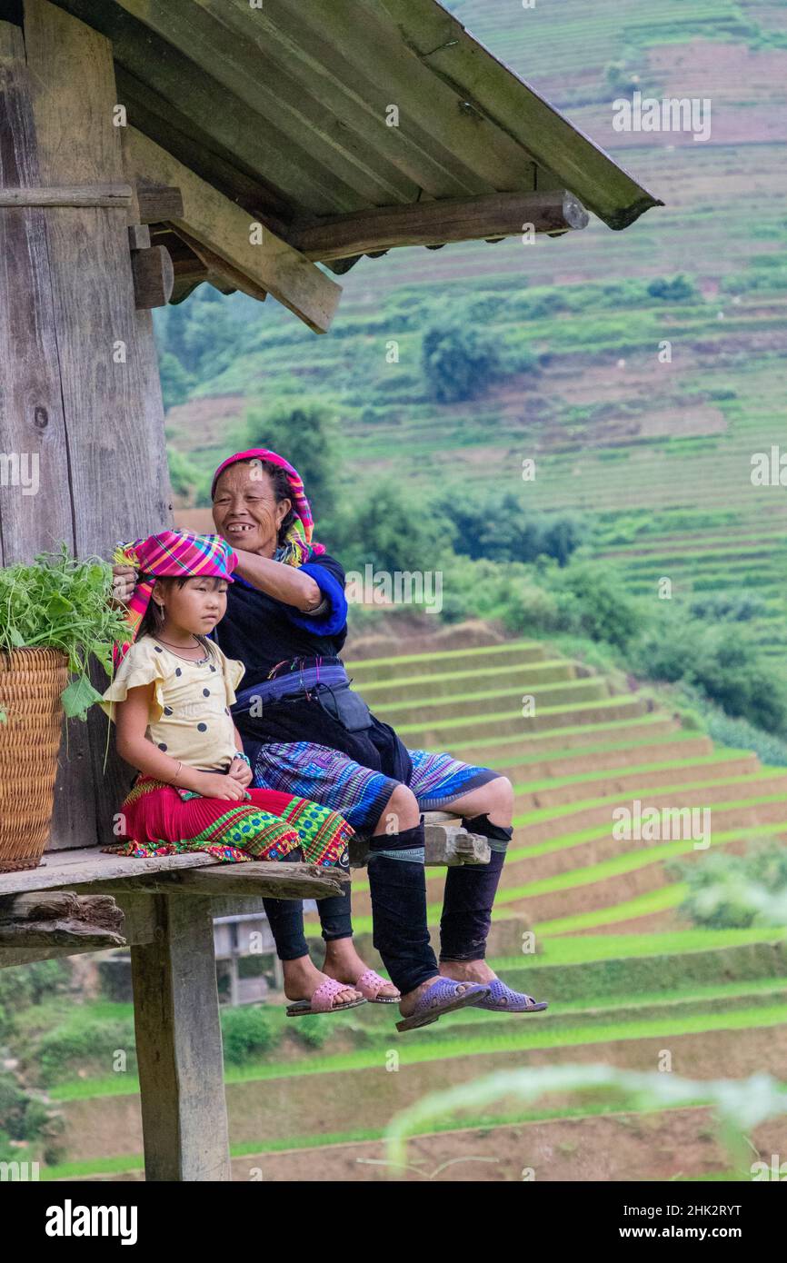 Vietnam. Grandma taking care of granddaughter. Farming community with ...