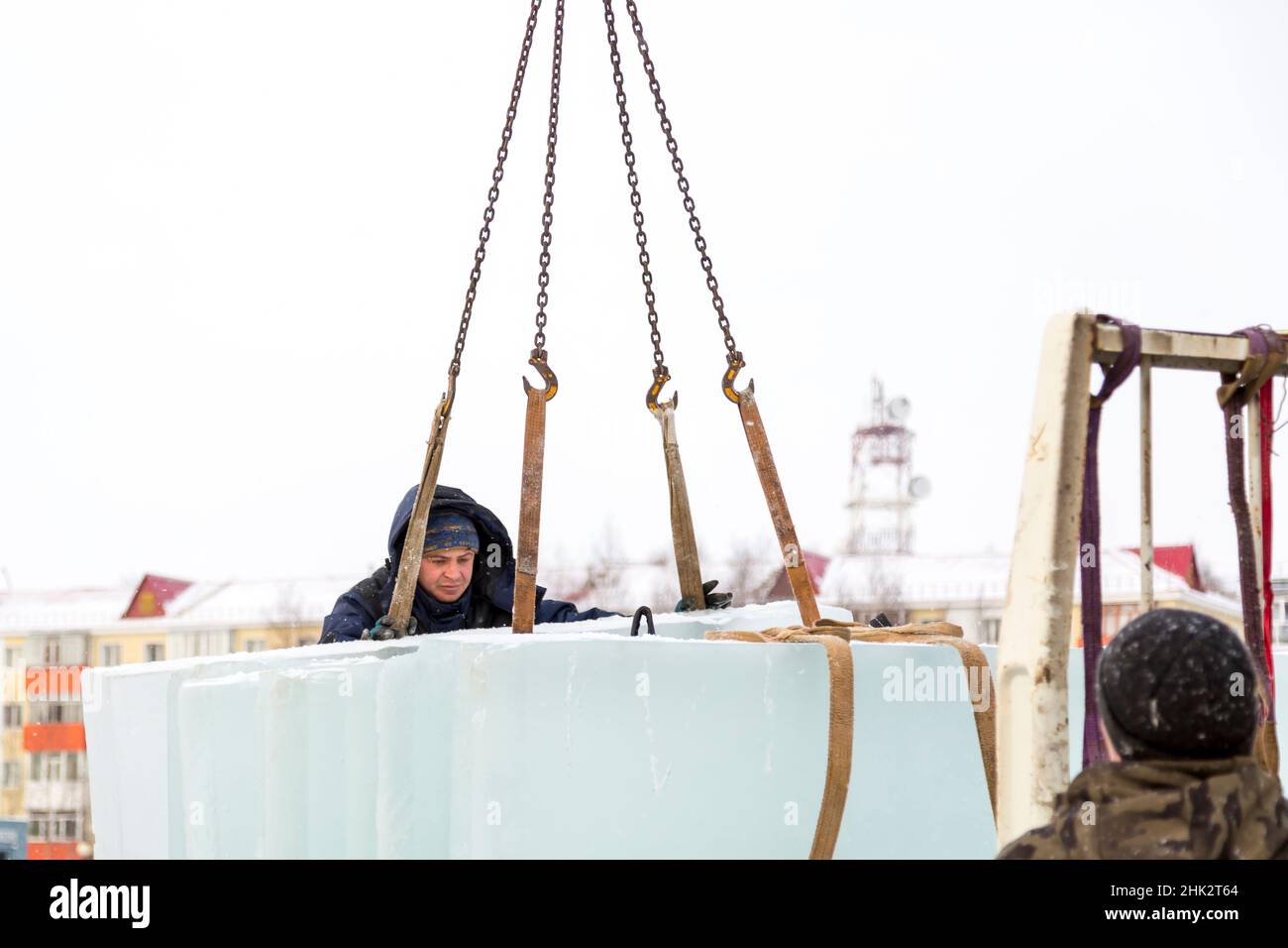 Two assembly workers unload ice plates from the body of a car Stock ...