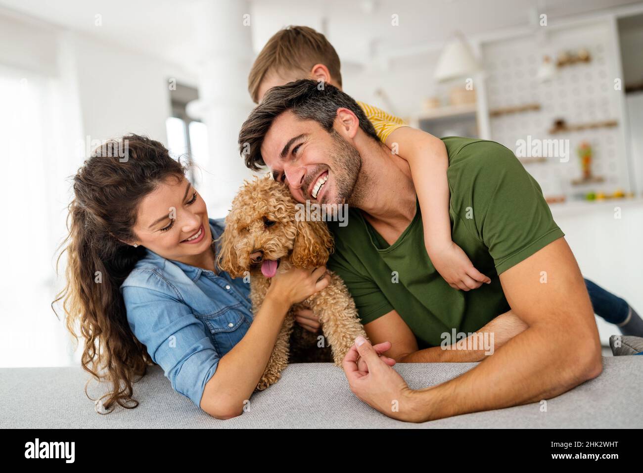 Portrait of happy family with a dog having fun together at home Stock ...