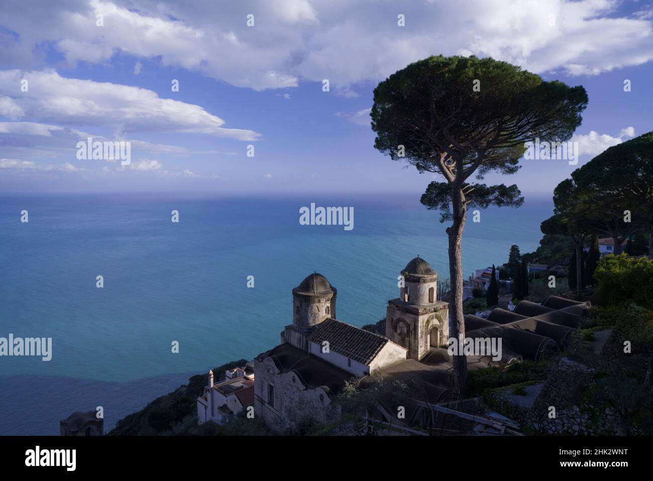 Europe, Italy, Ravello. Cypress tree and church domes overlook ocean ...