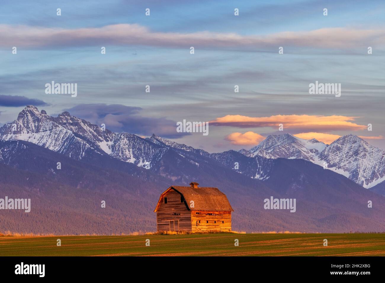 Rustic old barn in evening light with Mission Mountains in Pablo ...