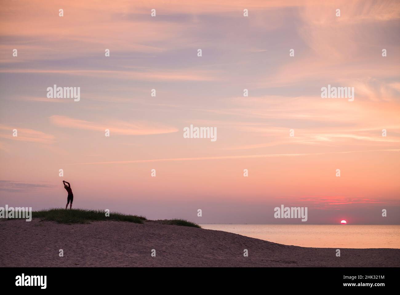 Sweden, Scania, Malmo, Riberborgs Stranden beach area, woman exercising ...