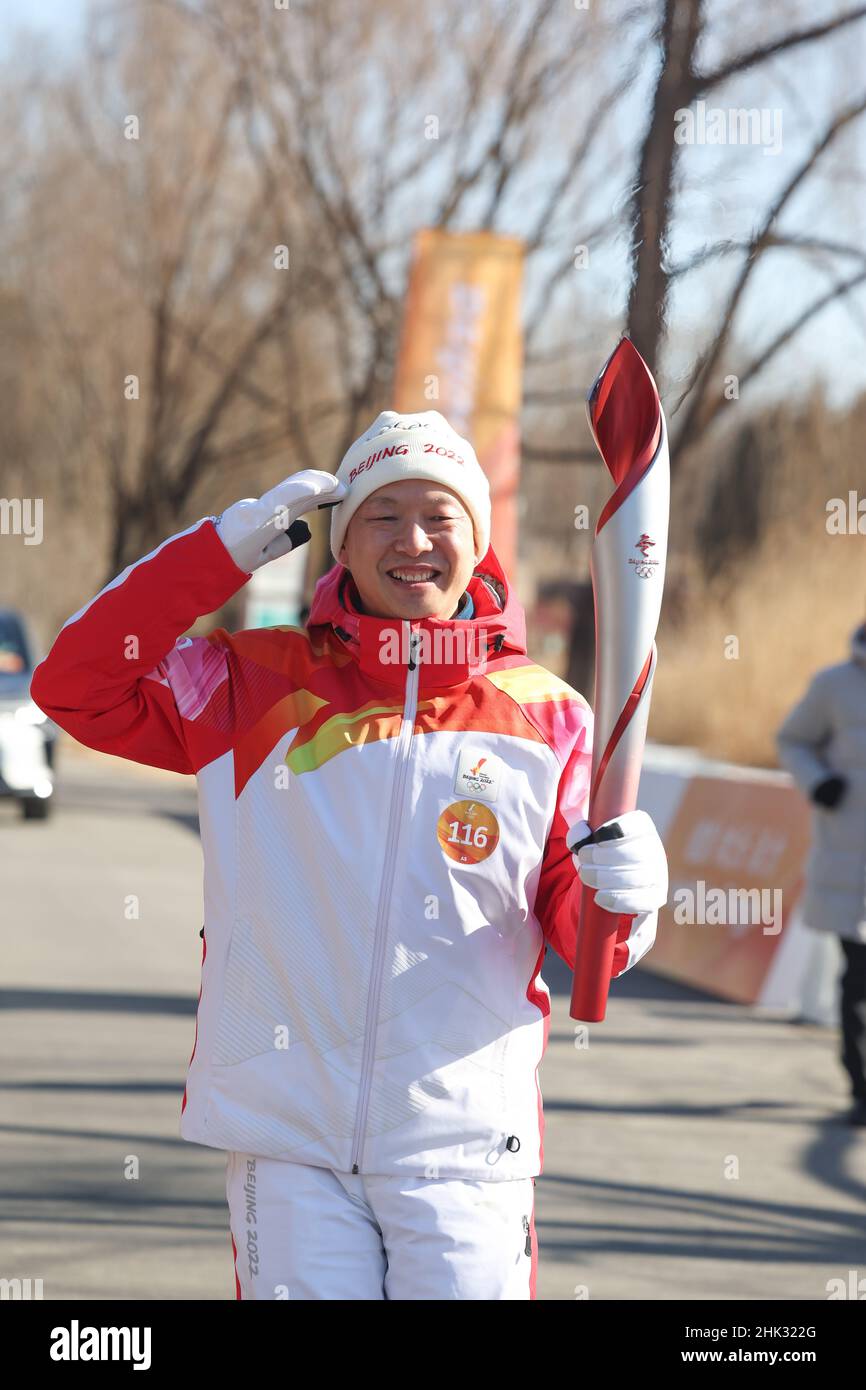 Beijing, China. 2nd Feb, 2022. Torch bearer Zhang Qi runs with the torch during the Beijing 2022 ...