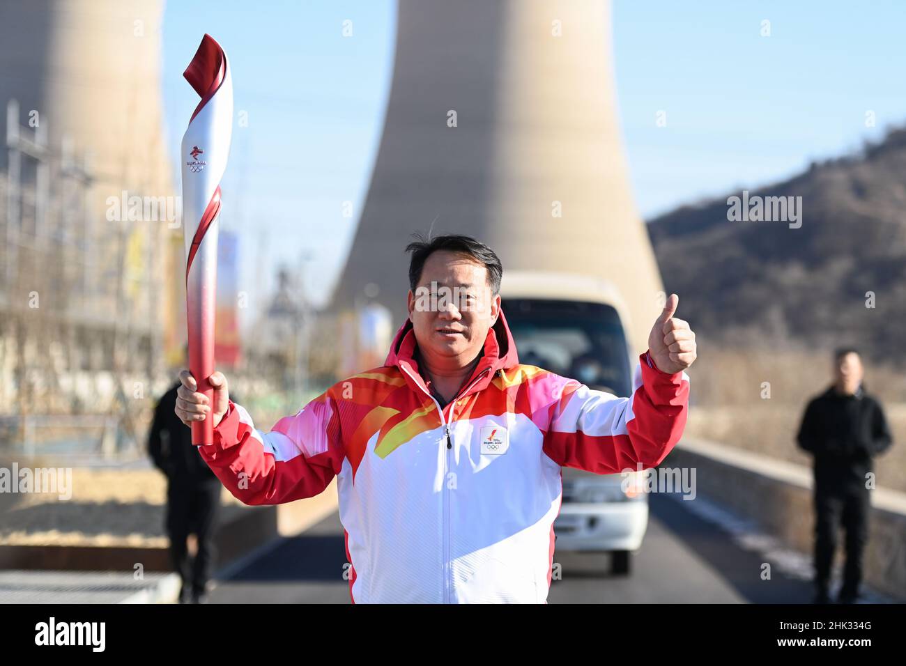 Beijing, China. 2nd Feb, 2022. Torch bearer Cai Zhiwei runs with the ...