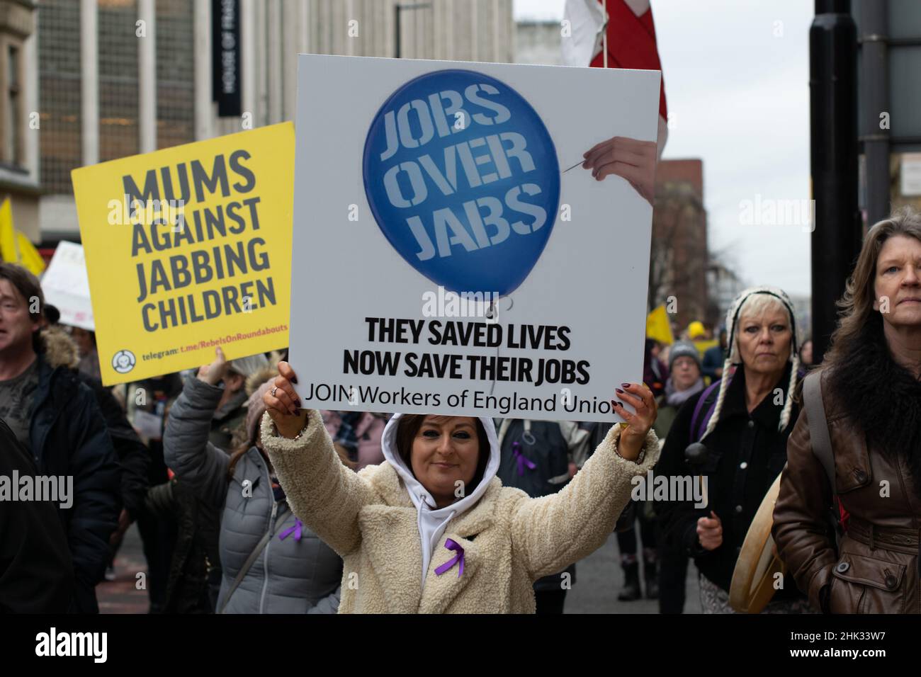 Anti Vax protest Deansgate. Protester holding banner text Jobs Over ...