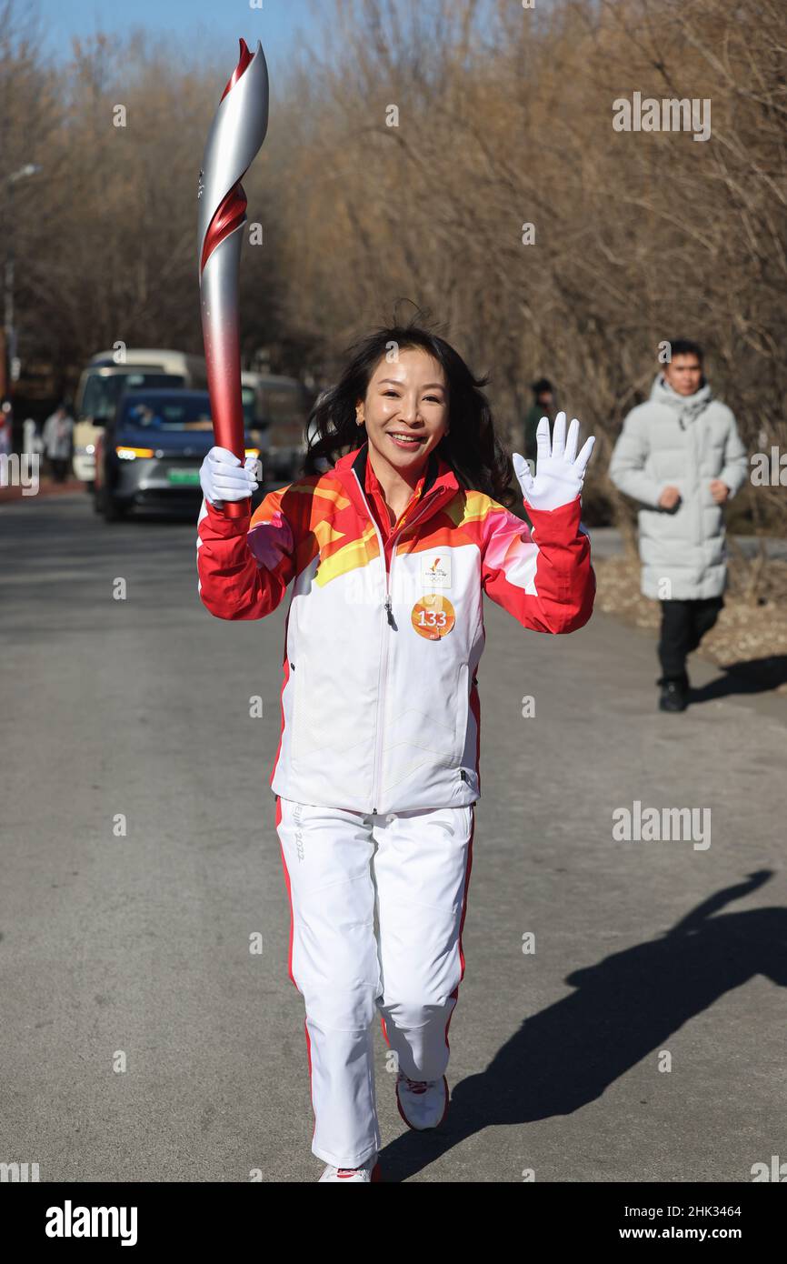 Beijing, China. 2nd Feb, 2022. Torch bearer Wang Xiaojie runs with the ...