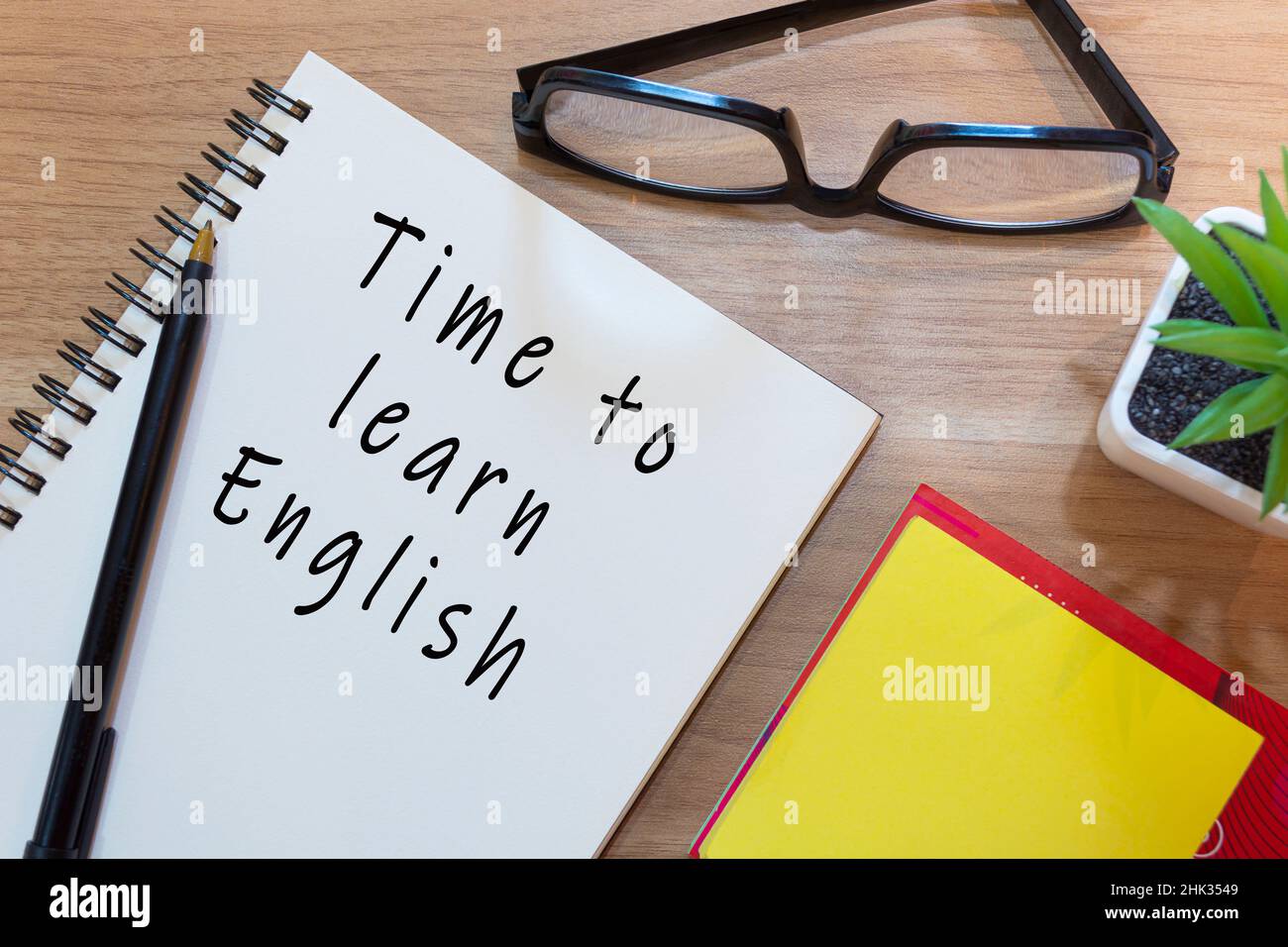 Text on notepad with yellow note, potted plant and study glasses - Time ...