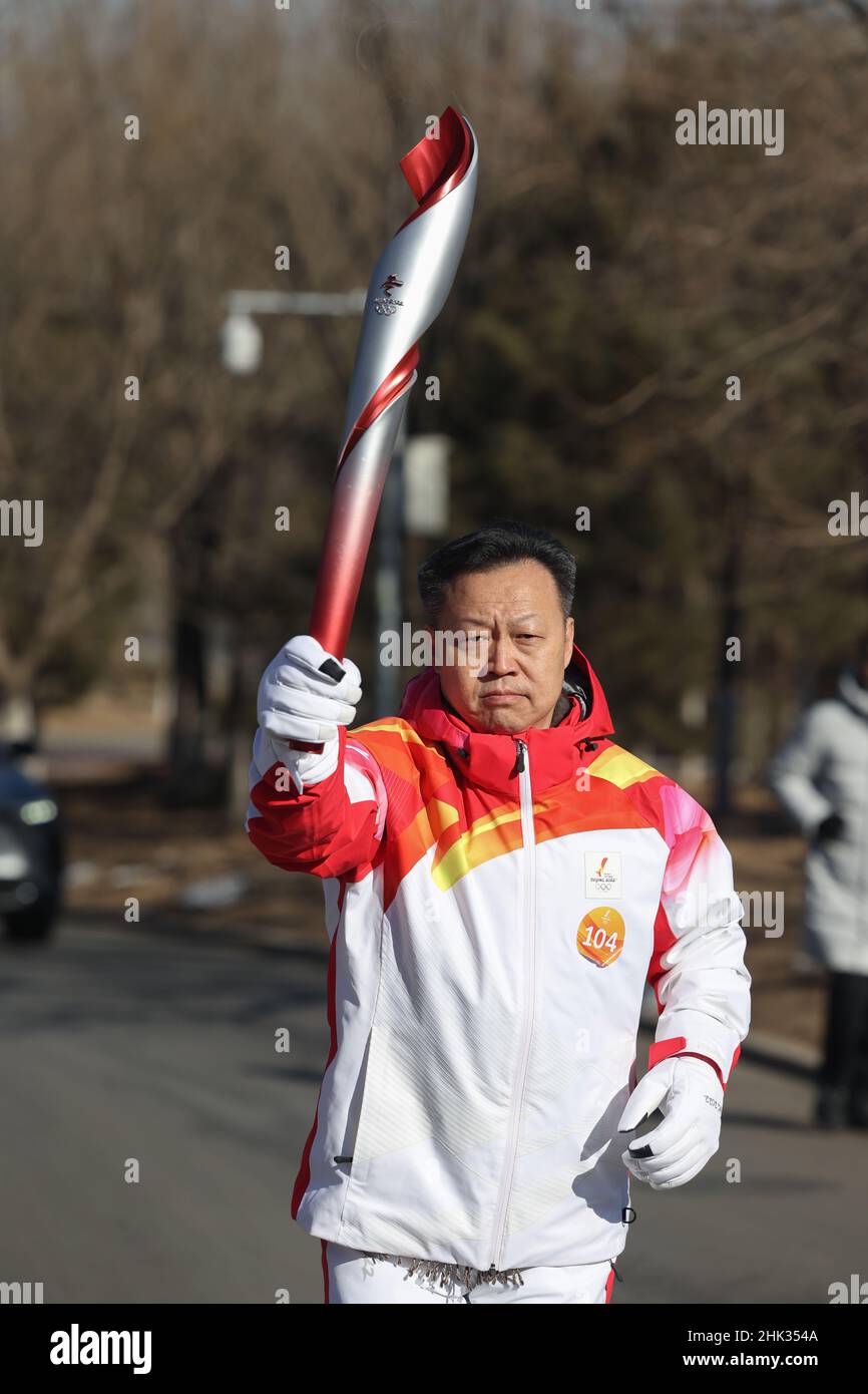 Beijing, China. 2nd Feb, 2022. Torch bearer Chen Ruiwu runs with the torch during the Beijing ...
