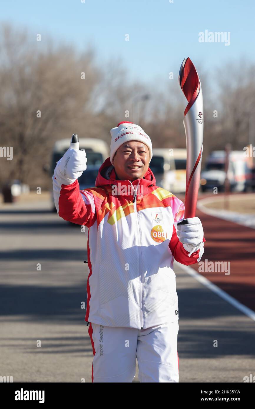Beijing, China. 2nd Feb, 2022. Torch bearer Zhao Qifeng runs with the torch during the Beijing ...