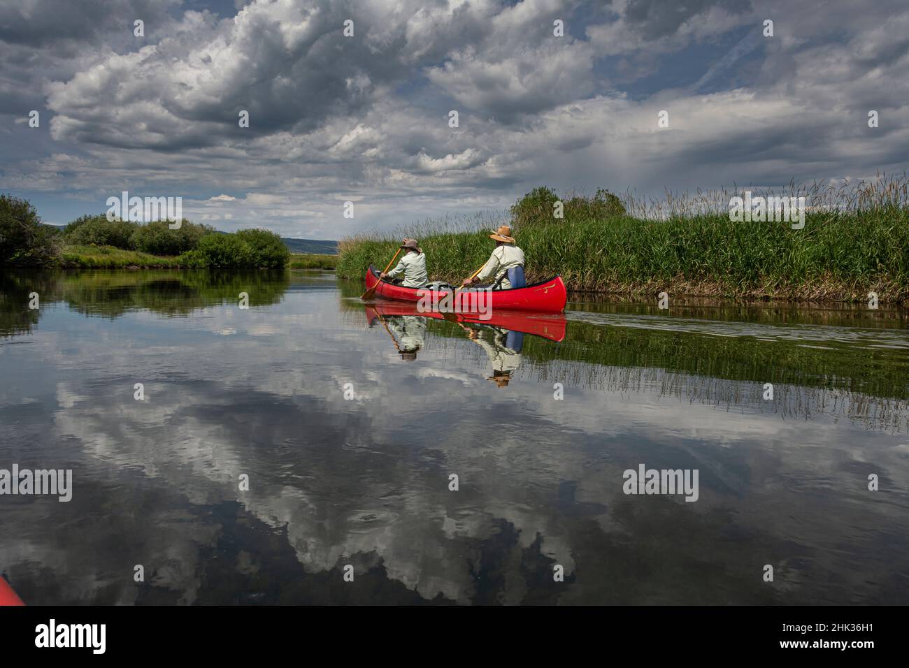 USA, Idaho. Couple in canoe enjoy sunny day on Teton River, Teton ...