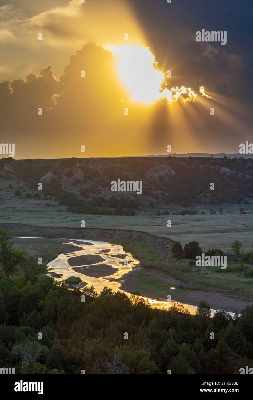 Setting sun rays poke through thunderstorm clouds above the Little ...