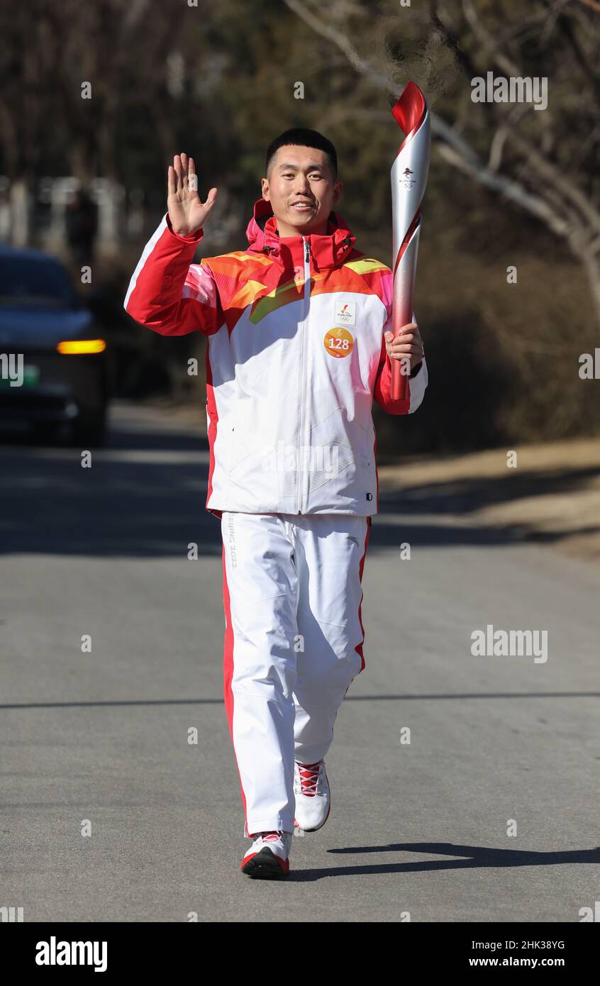Beijing, China. 2nd Feb, 2022. Torch bearer Zhang Zixuan runs with the torch during the Beijing ...