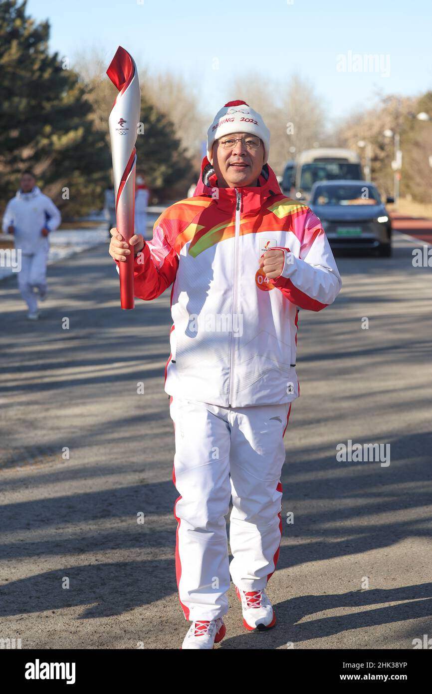 Beijing, China. 2nd Feb, 2022. Torch bearer Cui Jingshan runs with the ...