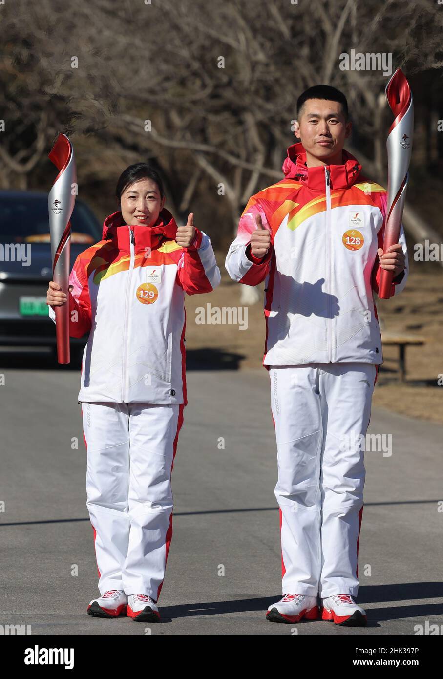 Beijing, China. 2nd Feb, 2022. Torch bearers Zhang Zixuan (R) and Chang ...