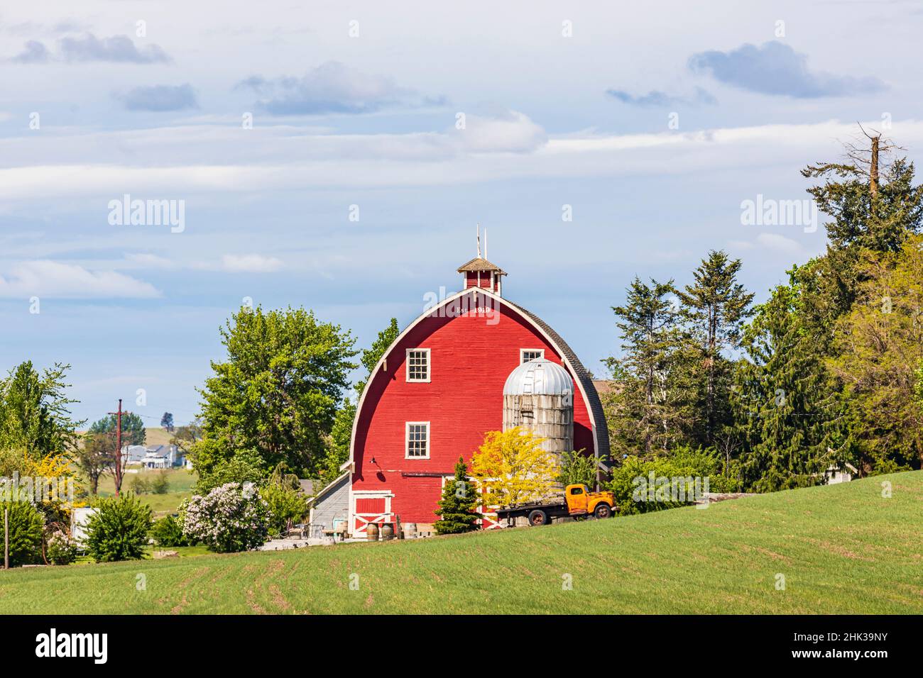 Colfax, Washington State, USA. Red barn and grain silo on a farm in the ...