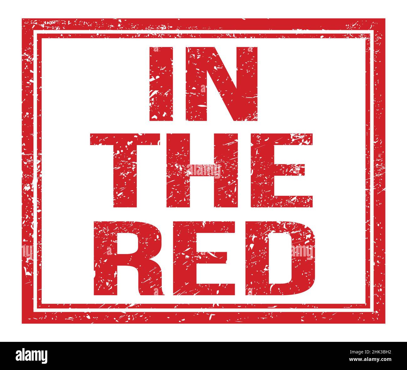 IN THE RED, written on red grungy stamp sign Stock Photo - Alamy