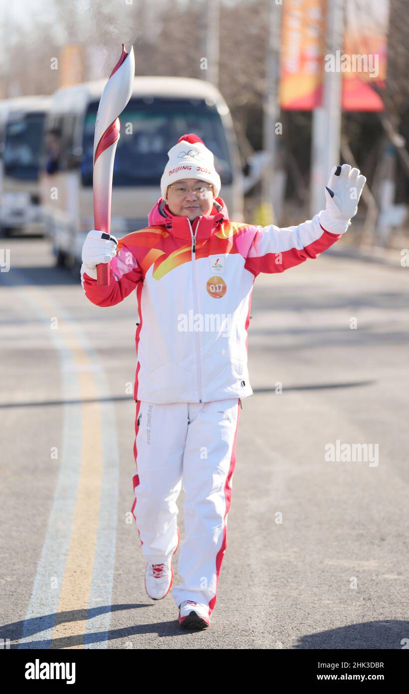 Beijing, China. 2nd Feb, 2022. Torch bearer Kang Yan runs with the ...