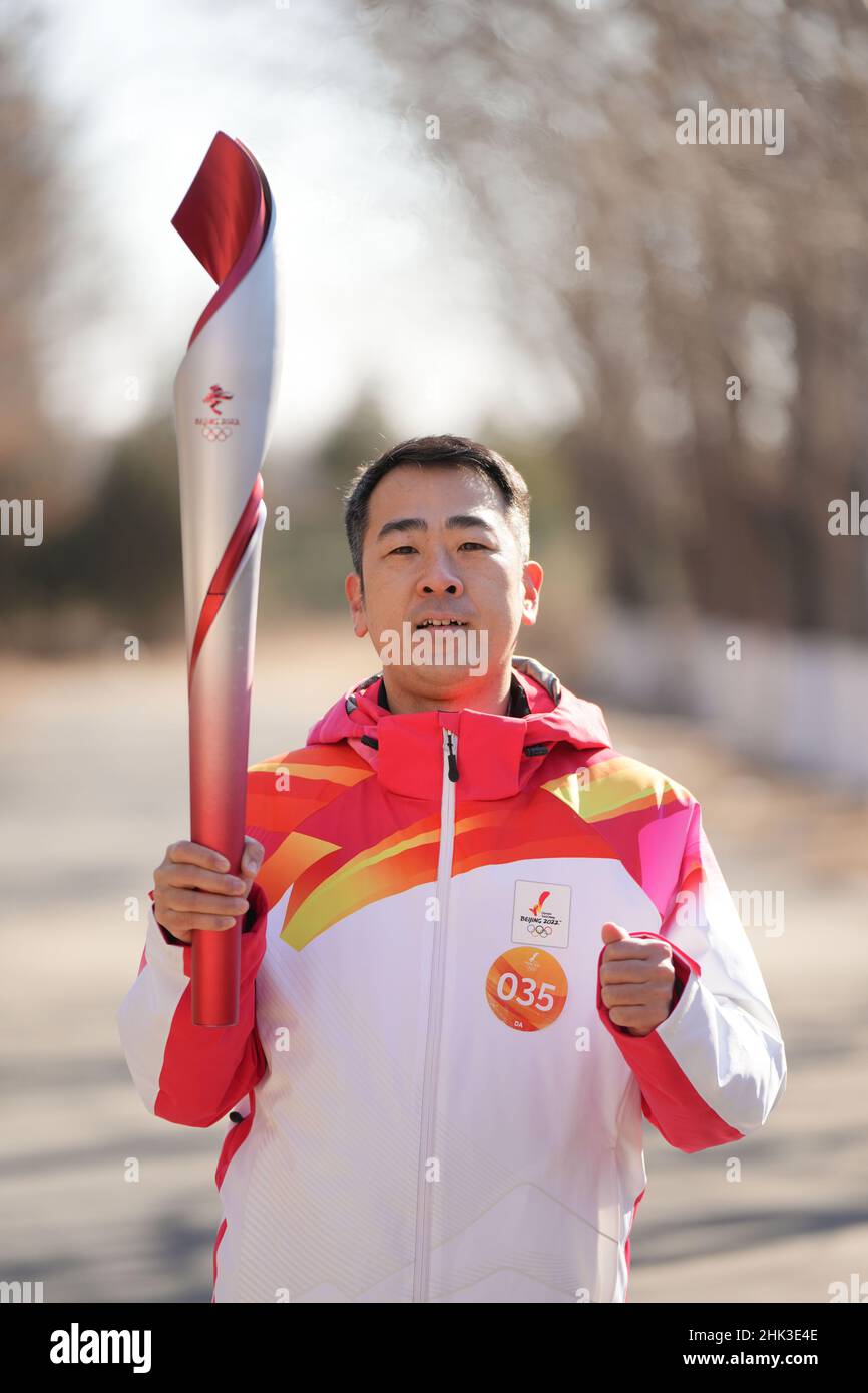 Beijing, China. 2nd Feb, 2022. Torch bearer Wang Luming runs with the torch during the Beijing ...