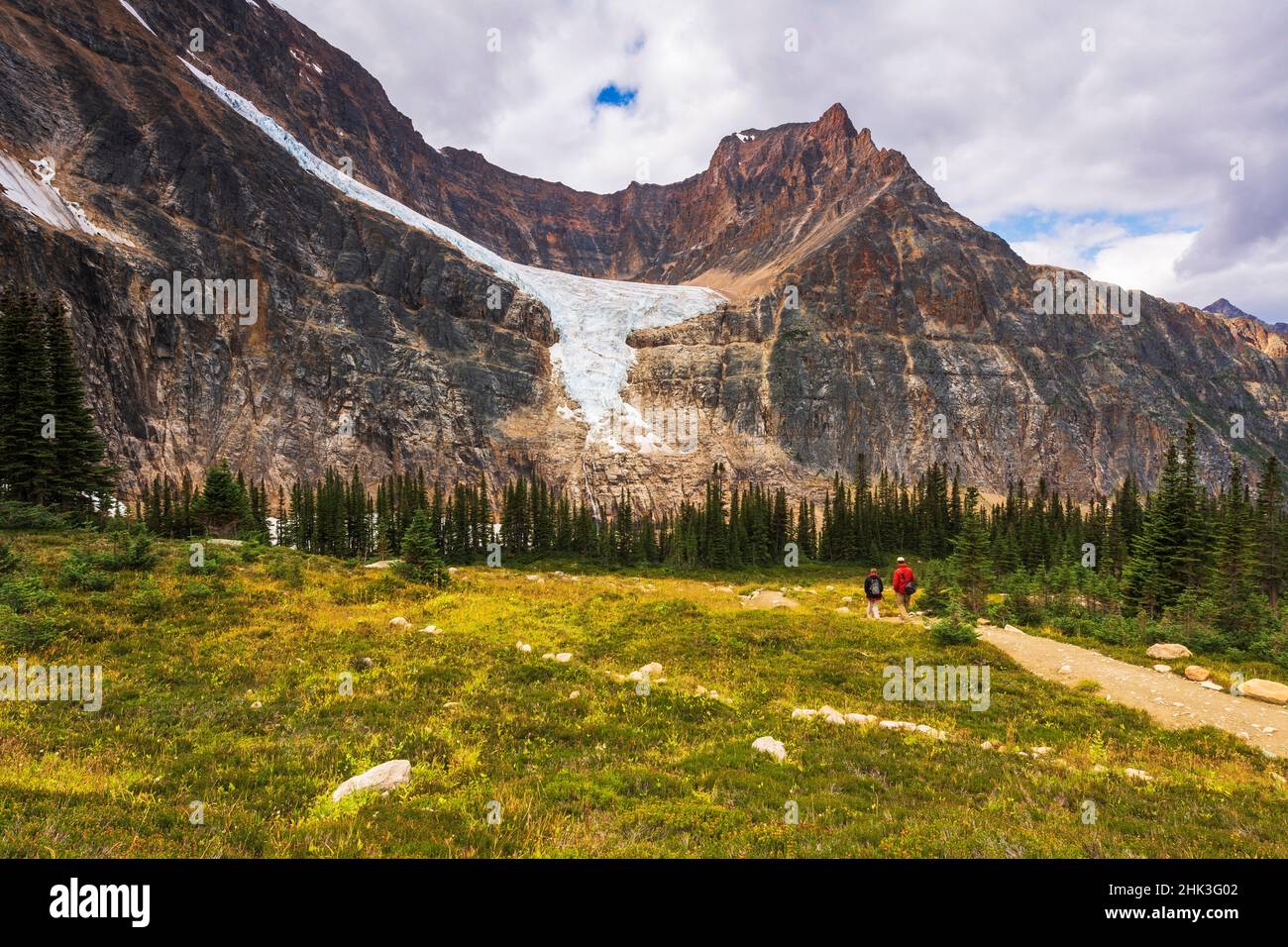 Hikers in Cavell Meadow under the Angel Glacier, Mount Edith Cavell ...