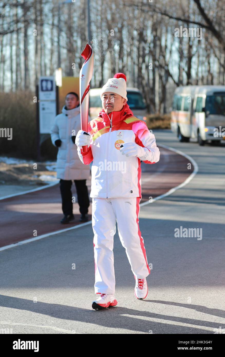 Beijing, China. 2nd Feb, 2022. Torch bearer Ding Shizhong runs with the torch during the Beijing ...