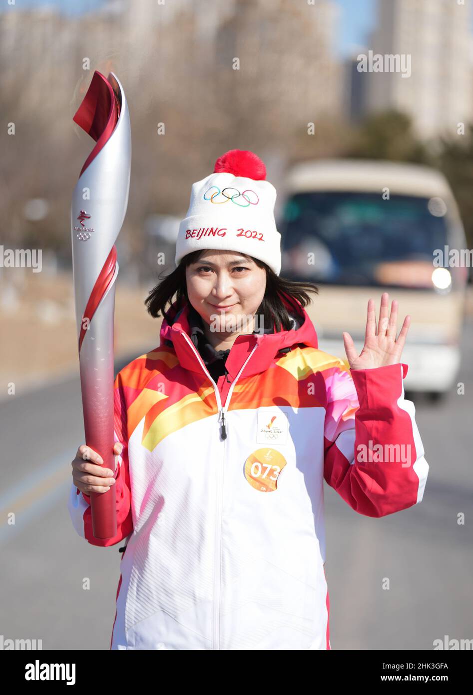 Beijing, China. 2nd Feb, 2022. Torch bearer Zhang Fang runs with the torch during the Beijing ...