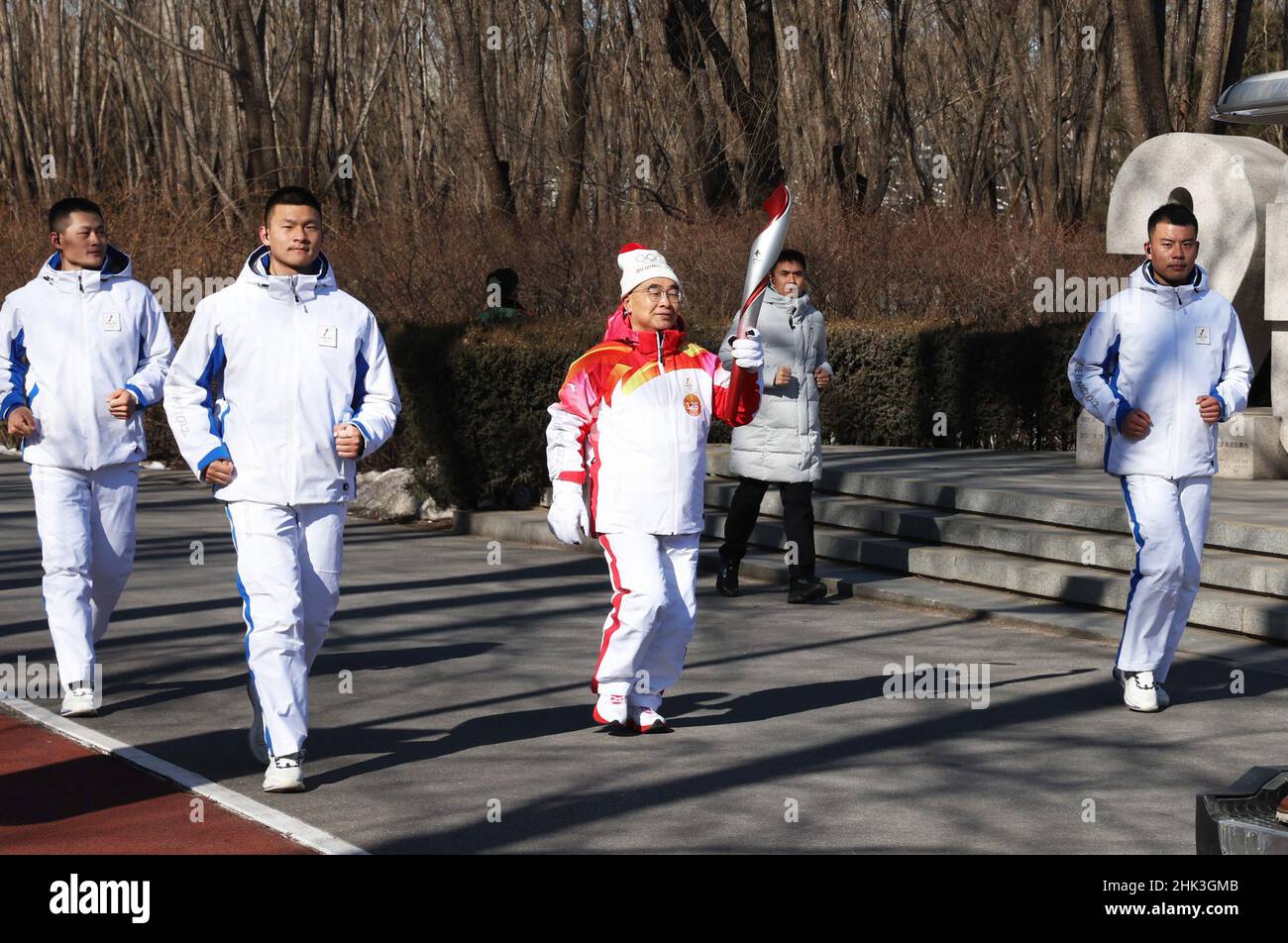 Beijing, China. 2nd Feb, 2022. Torch bearer Zhang Boli runs with the torch during the Beijing ...