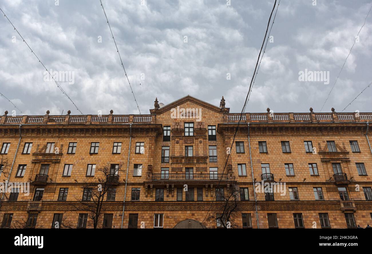 Front view of yellow brick building with windows and cloudy sky Stock ...