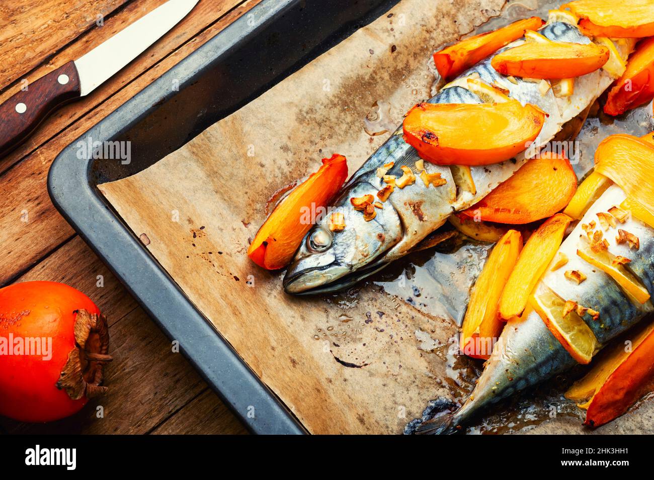 Healthy food, baked mackerel. Fish in persimmon fruit Stock Photo - Alamy