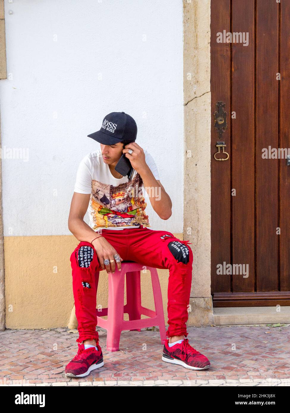 Portugal, Tomar. Portuguese young man talking on his cell phone during ...