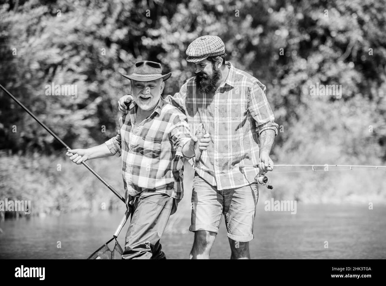 funny fishing. male friendship. family bonding. two happy fisherman ...