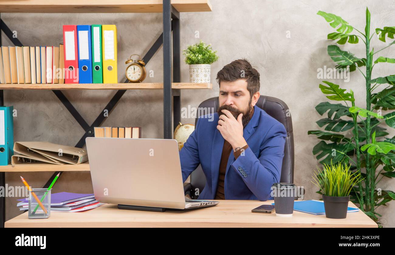 busy mature entrepreneur working on computer at office, professional ...