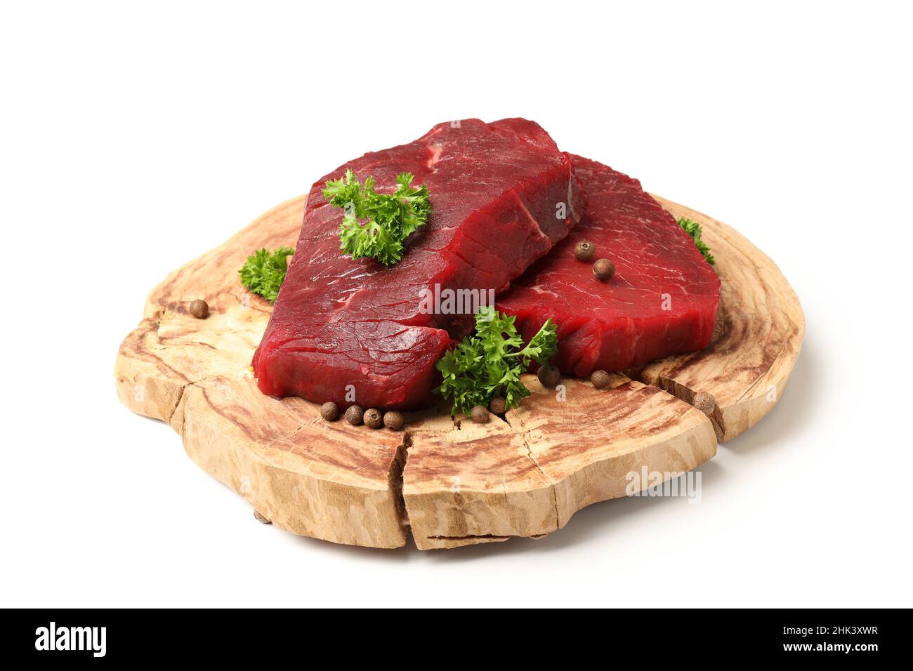 Piece of log with raw beef steaks isolated on white background Stock ...